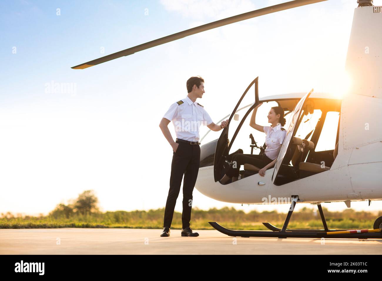 Cheerful Chinese helicopter pilots talking Stock Photo - Alamy