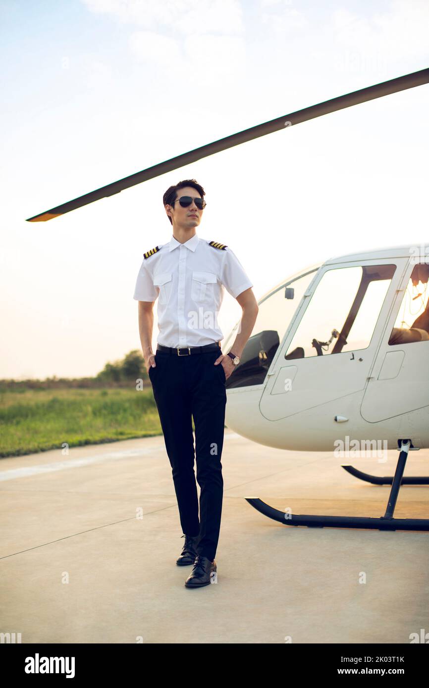 Chinese helicopter pilot standing by the vehicle Stock Photo - Alamy