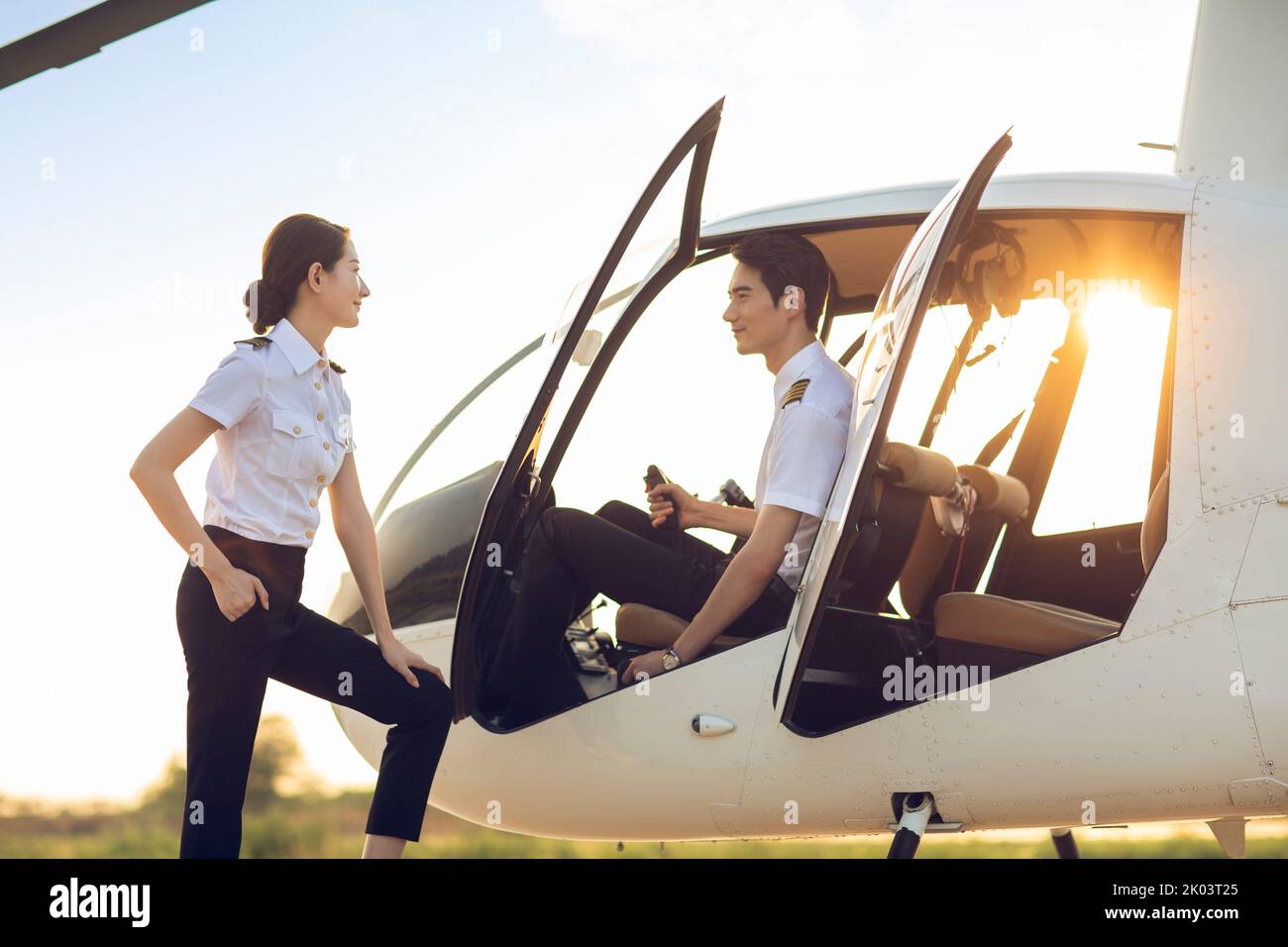 Cheerful Chinese helicopter pilots talking Stock Photo - Alamy