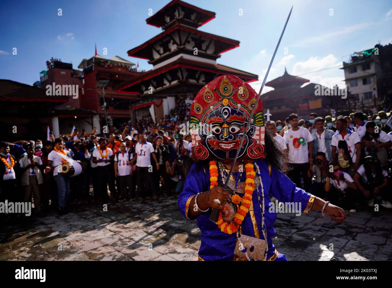 A masked dancer donned as deity performs during the festival at ...