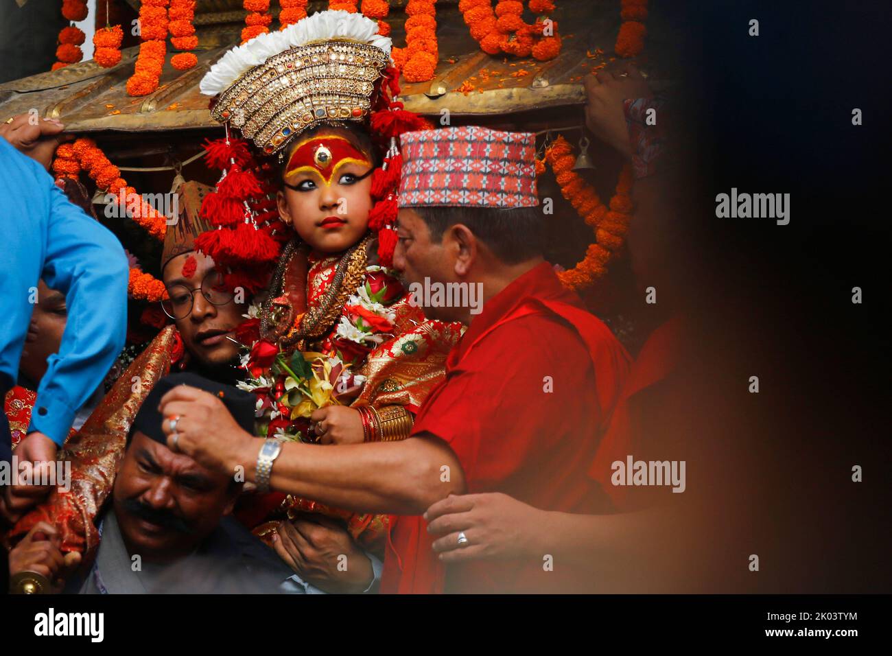 Caretakers carry Nepal’s Living Goddess Kumari on her chariot during ...