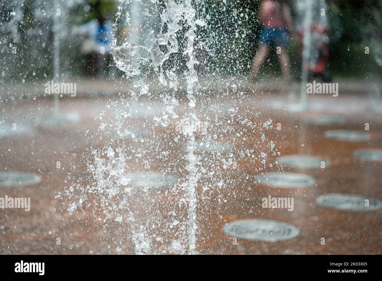 Fountain water jets rising from marble tiles Stock Photo - Alamy