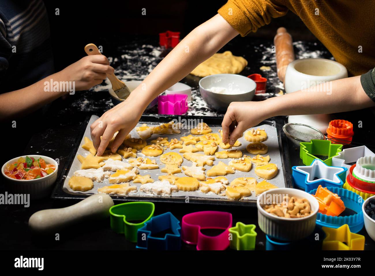 Making cookies by children. Cookies of different shapes are laid out on ...