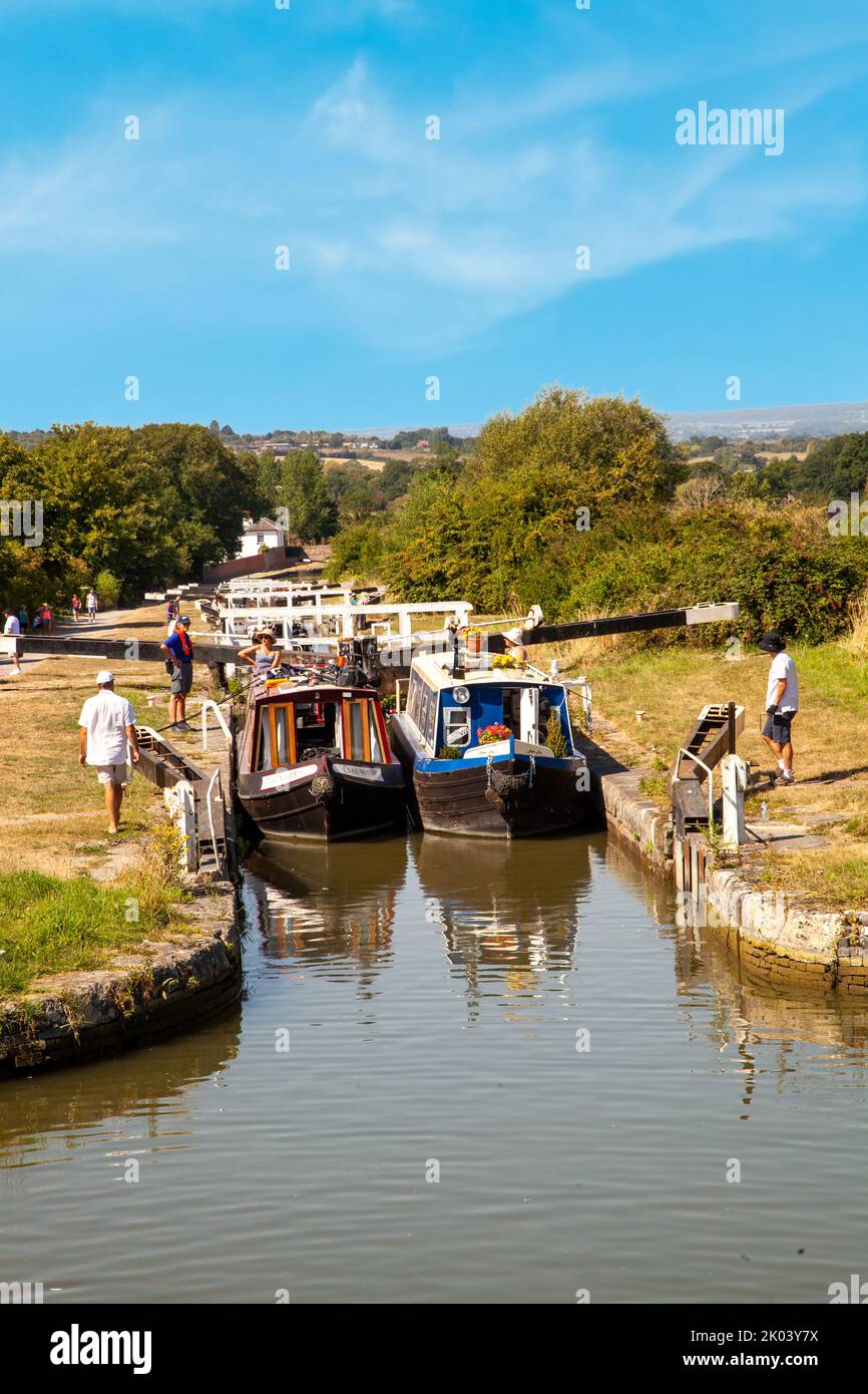 Canal narrowboats at Caen Hill Locks, a flight of 29 locks on the ...