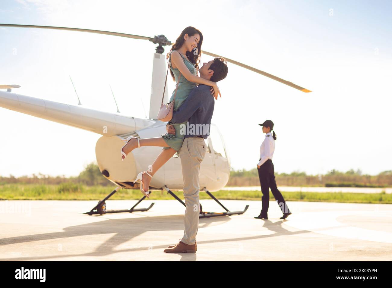 Young Chinese couple travelling by helicopter Stock Photo - Alamy