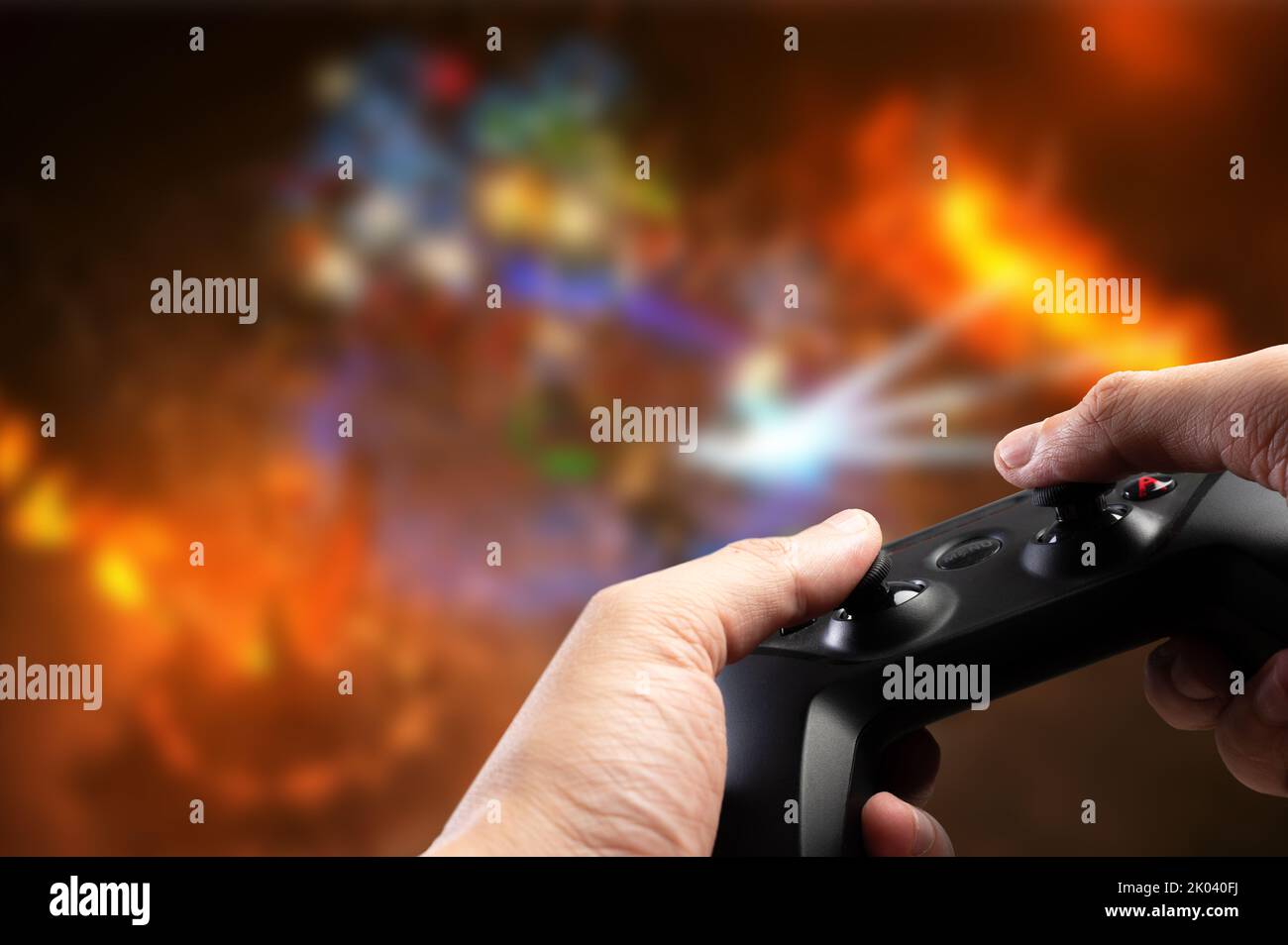 Joystick, gamepad GAM22ICB in the hands of a person on a bright fantasy ...