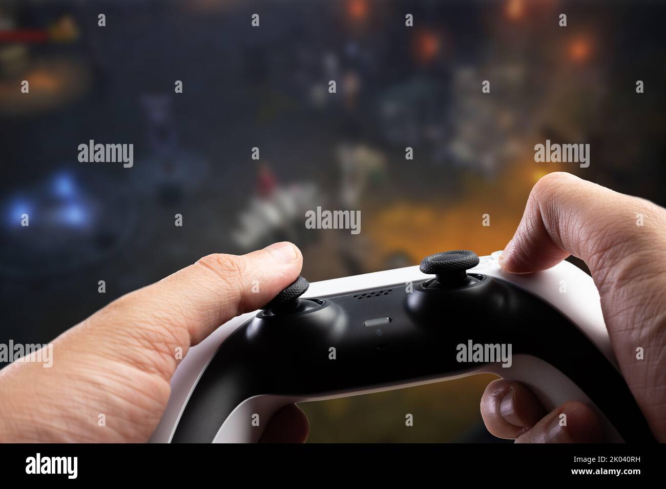 A modern GAM22ICB gamepad in the hands of a person against the backdrop ...