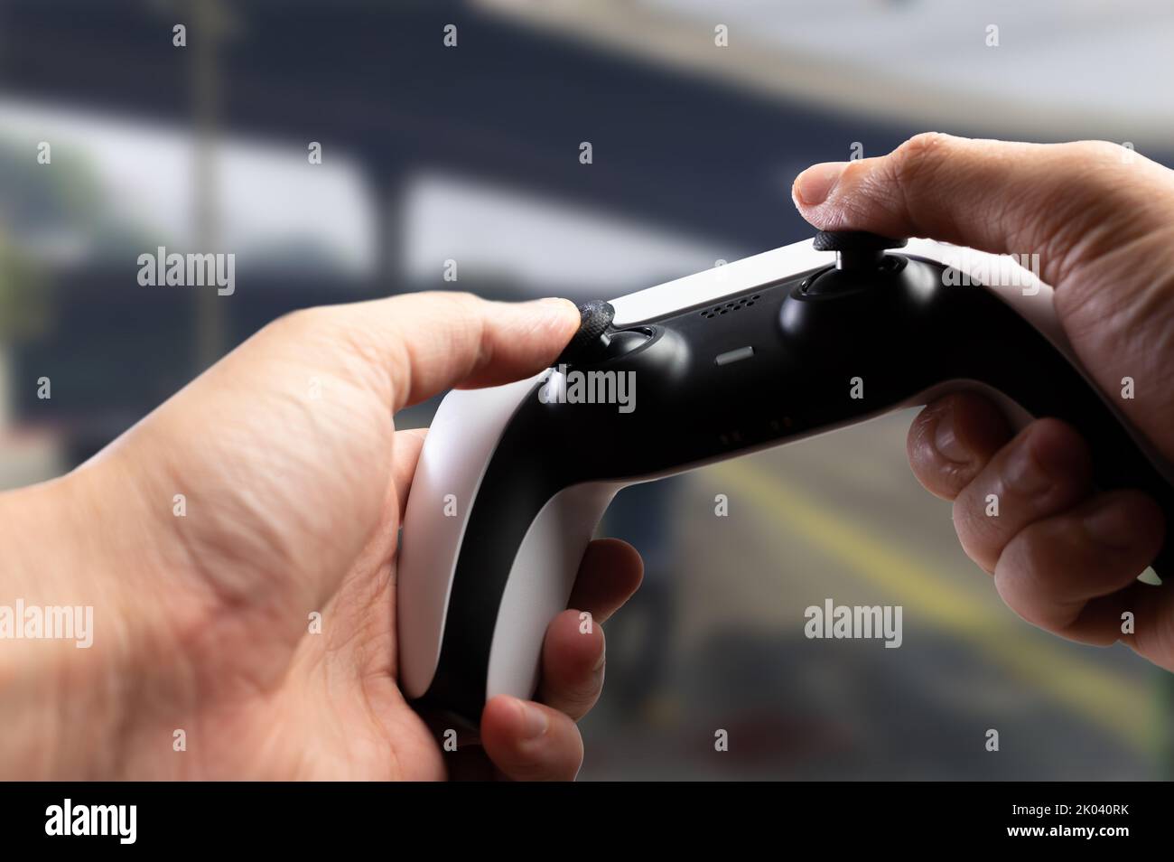 Gamepad GAM22ICB in the hands of a gamer on the background of a large ...