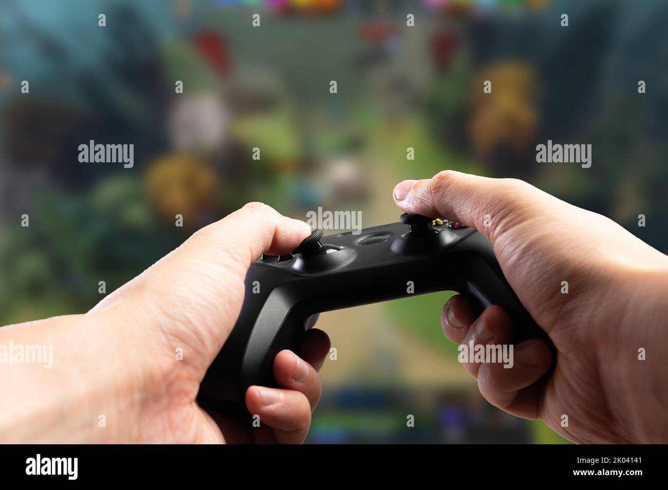Joystick, gamepad GAM22ICB in the hand of a gamer on the background of ...