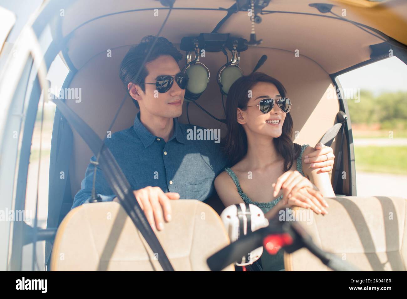Happy young Chinese couple on a helicopter Stock Photo - Alamy