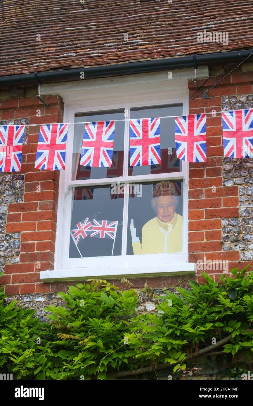 A hand-painted cut-out of Her Majesty Queen Elizabeth II looks down ...