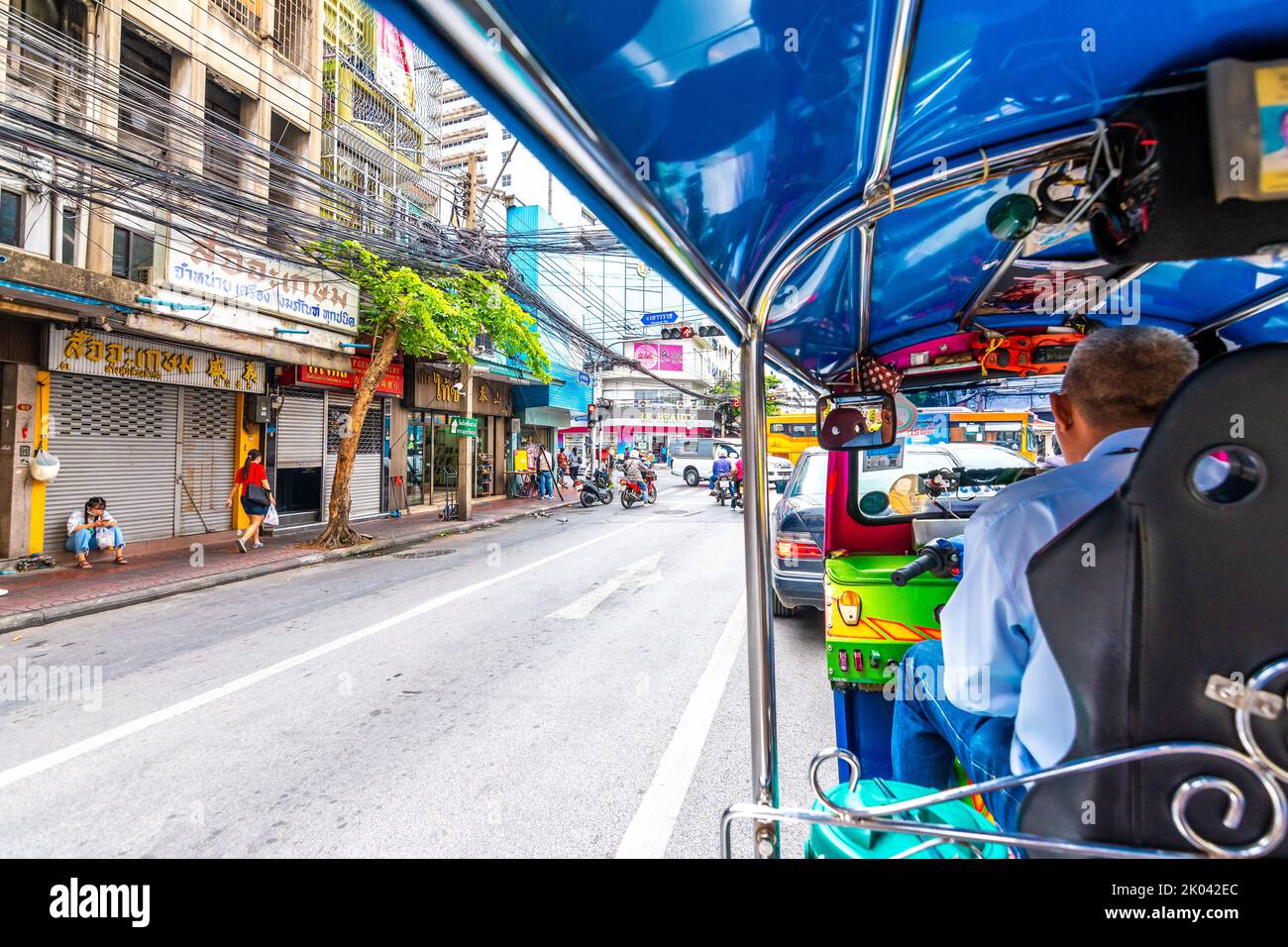 BANGKOK, THAILAND - 1.11.2019: View from the tuk tuk taxi car in Bangkok city. Thai driver in ...
