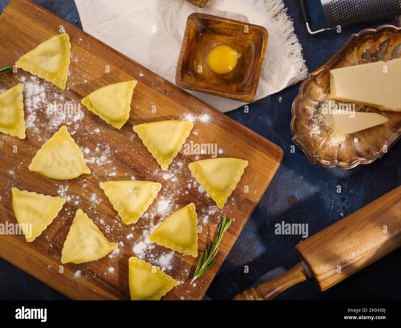 Triangular raw ravioli on a floured cutting board. Food background ...