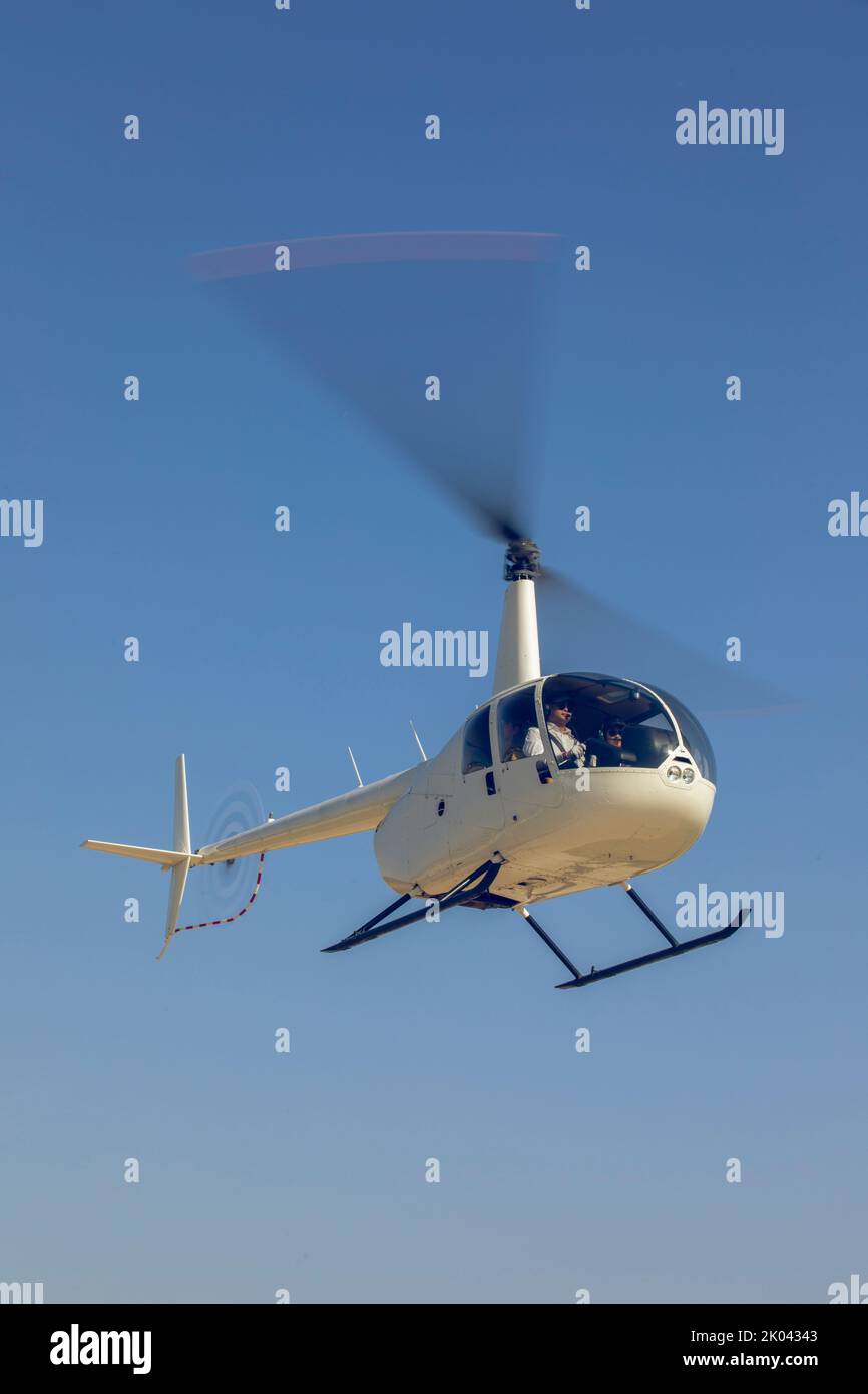 A helicopter flying in the sky Stock Photo - Alamy
