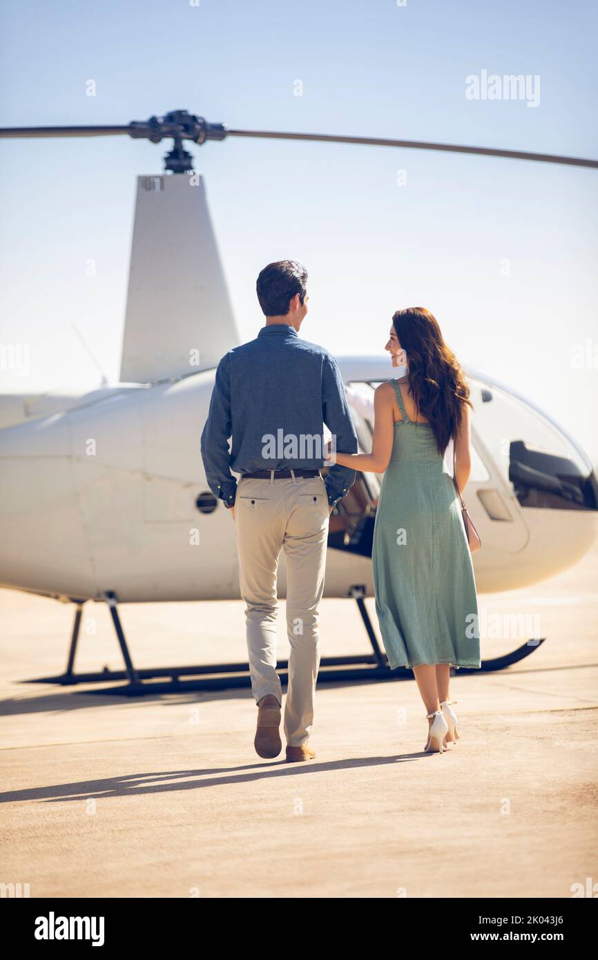 Young Chinese couple travelling by helicopter Stock Photo - Alamy