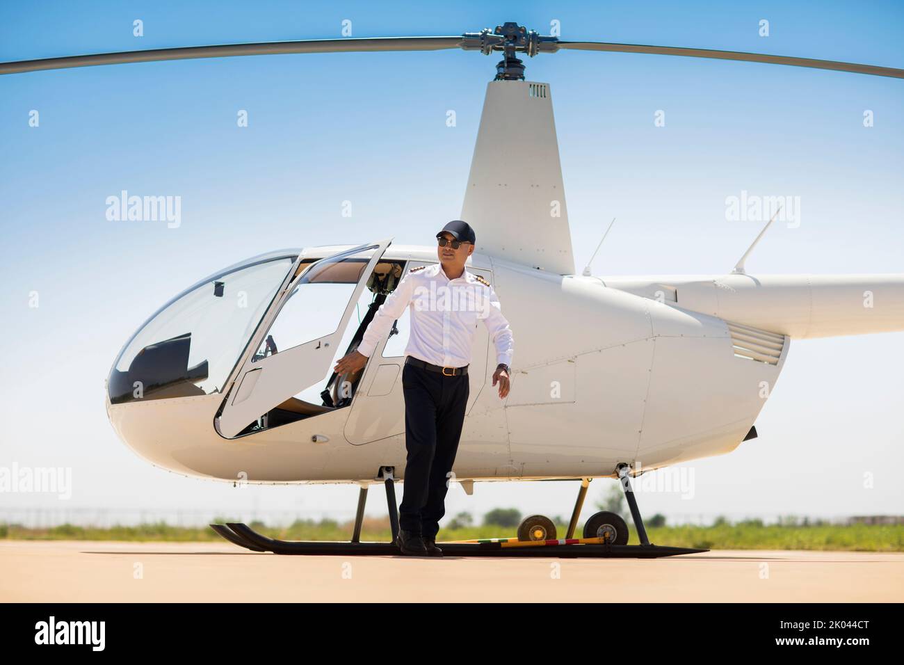 Chinese helicopter pilot standing by the vehicle Stock Photo - Alamy