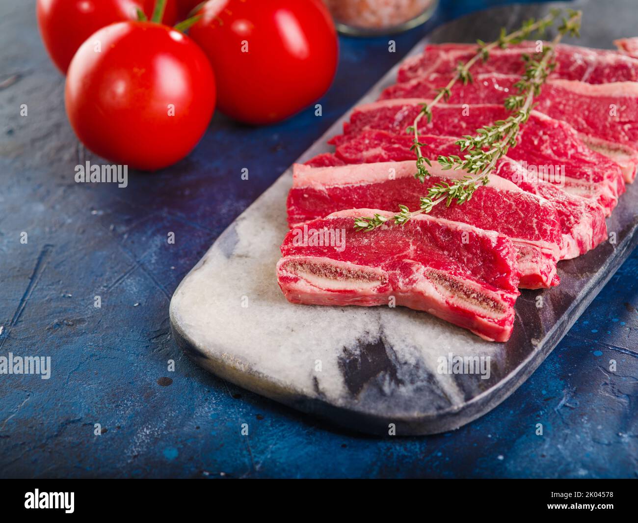 Raw meat steaks from organic meat from the farm, ripe tomatoes on a ...
