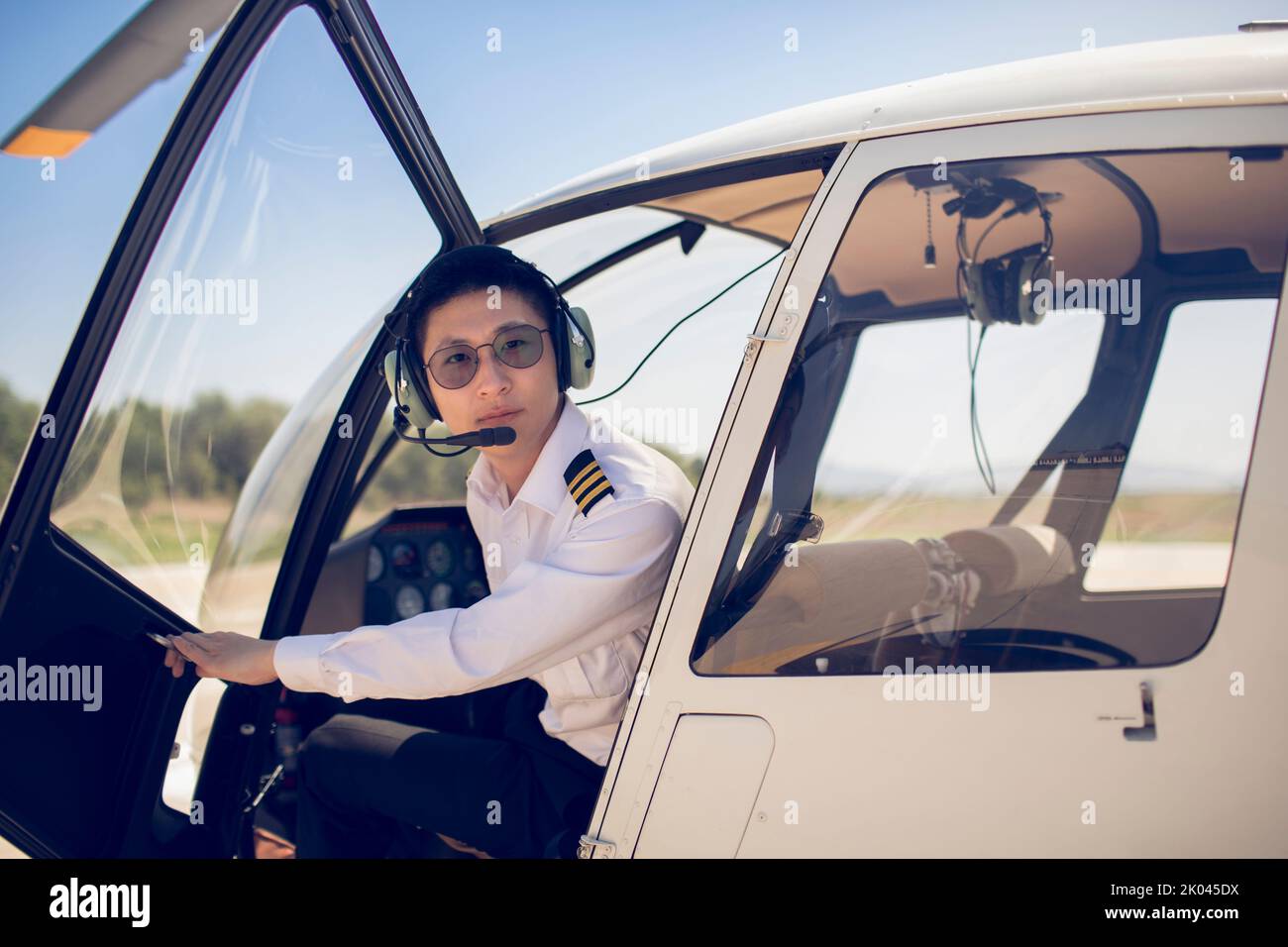 Chinese pilot sitting in helicopter cockpit Stock Photo - Alamy