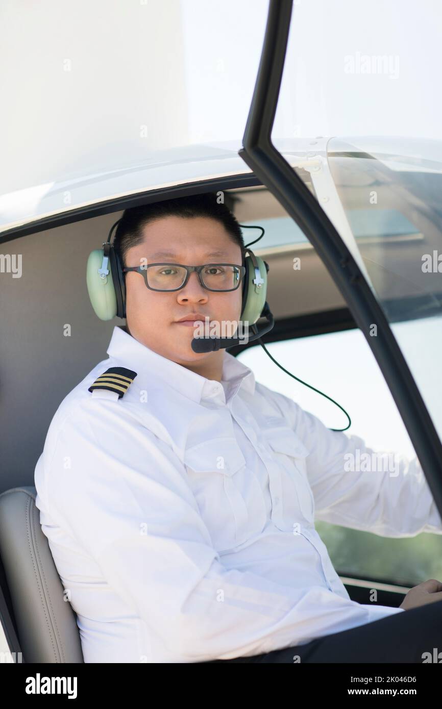 Close-up of Chinese pilot in helicopter cockpit Stock Photo - Alamy