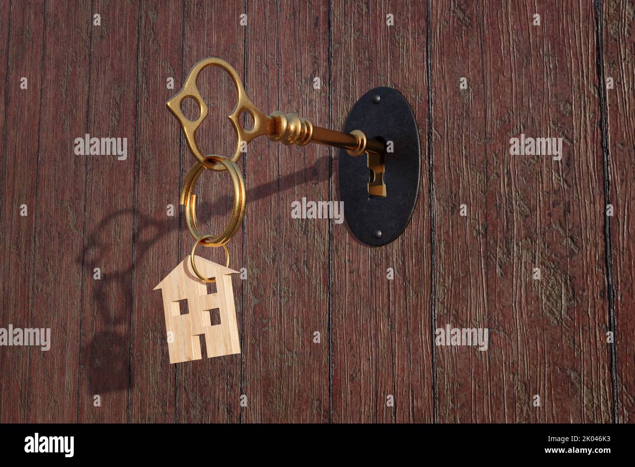 Old golden key having a wooden house shaped key holder in a wooden door ...