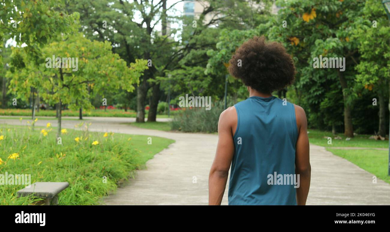 Back of african american person walking in nature outdoors ...