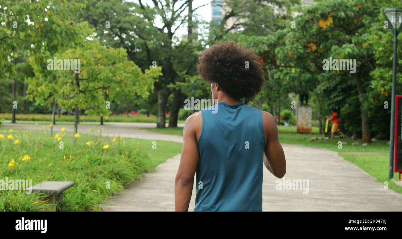Back of african american person walking in nature outdoors ...