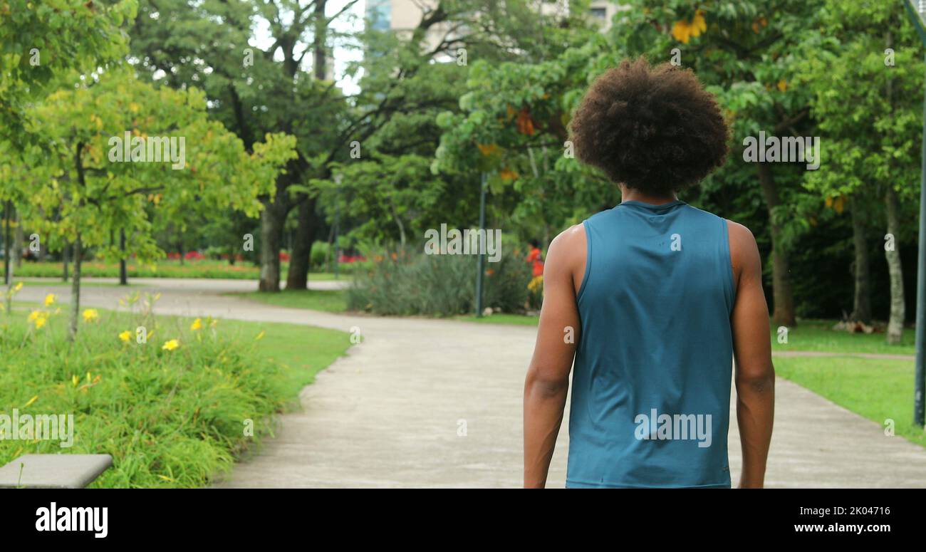 Happy thoughtful african man walking hi-res stock photography and ...