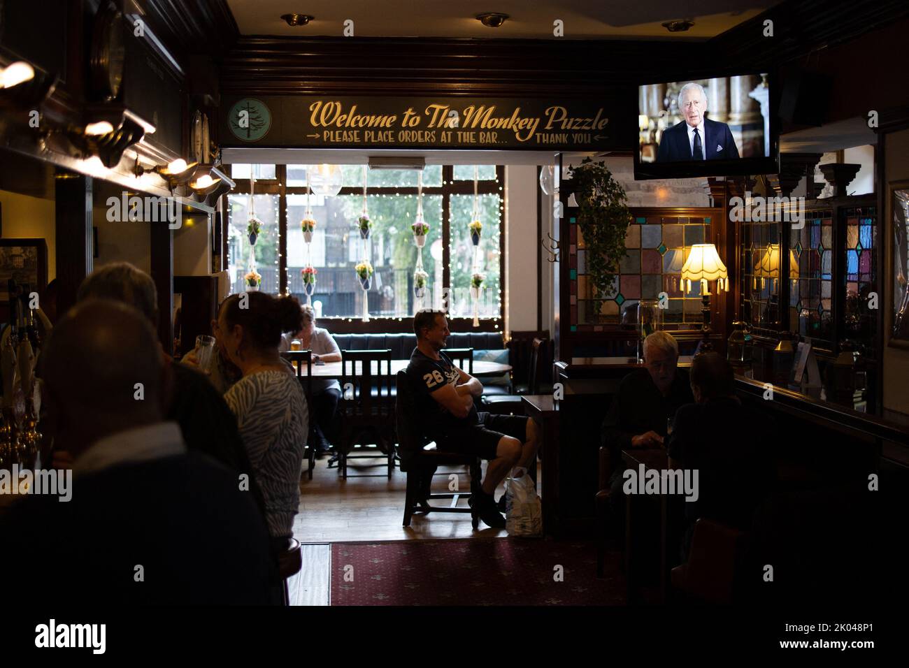 People watch King Charles III first television address as the King in a ...