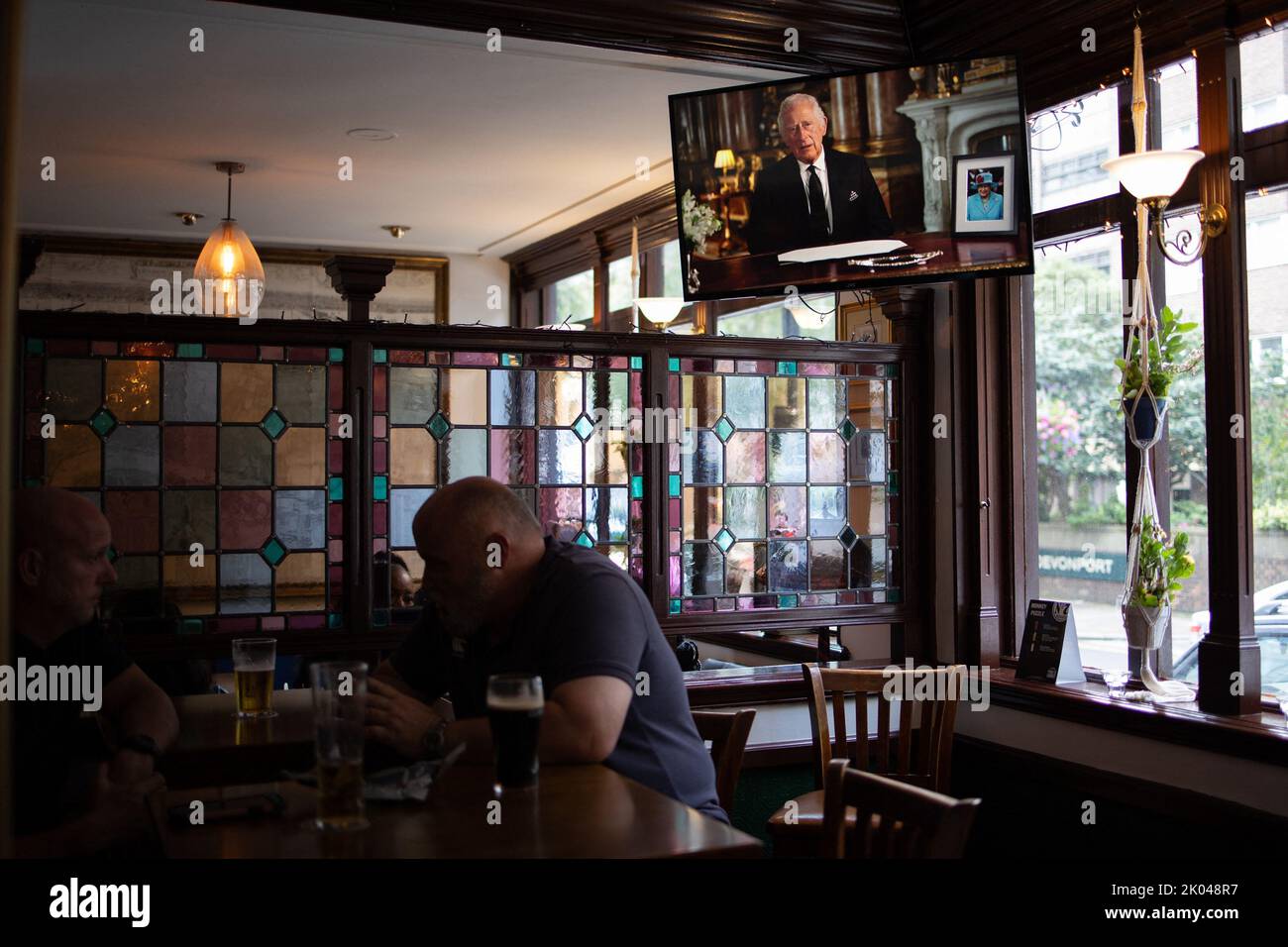 People watch King Charles III first television address as the King in a ...