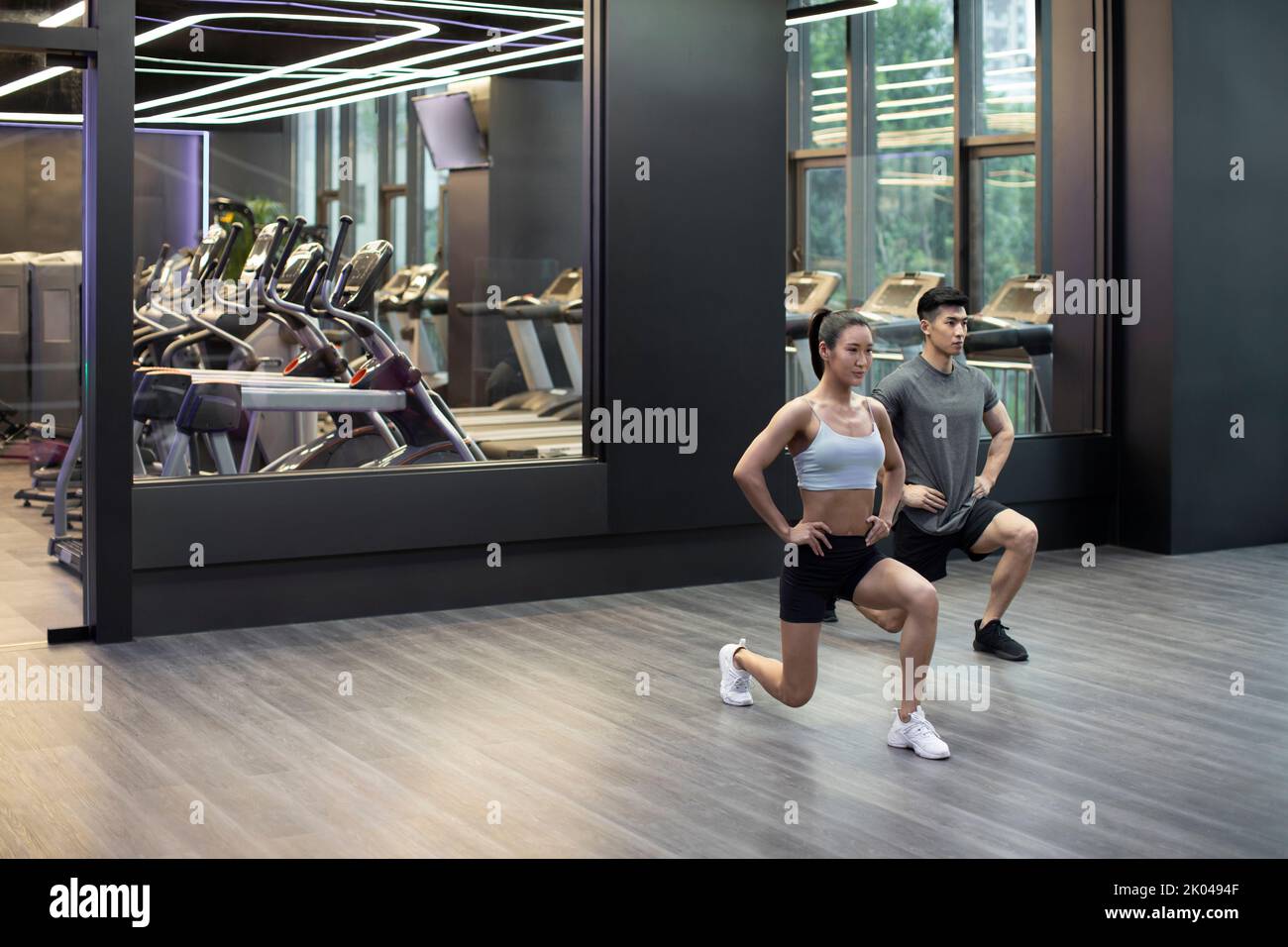 Young Chinese couple exercising at gym Stock Photo - Alamy