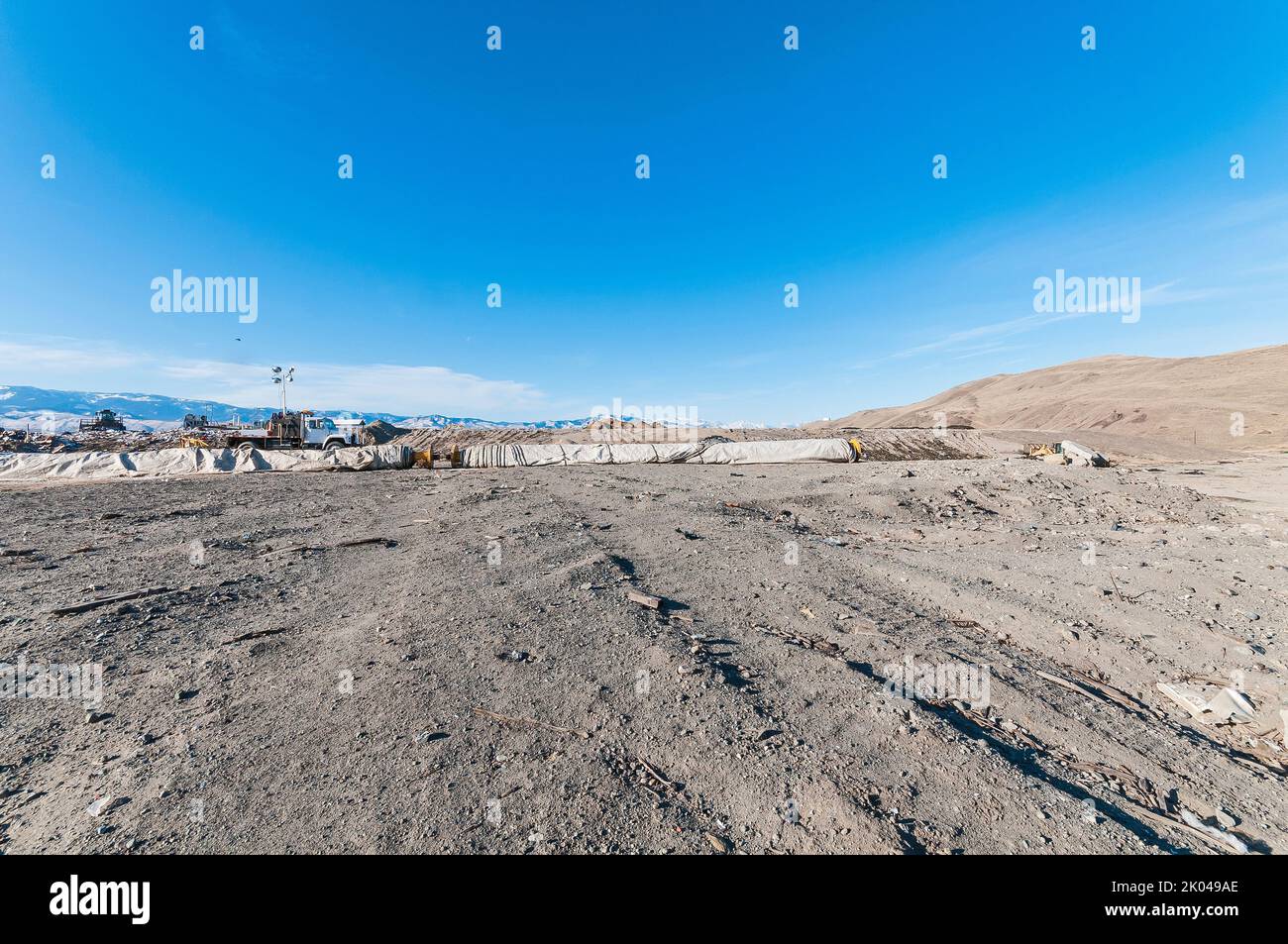 A parked utility truck with lighting for night work at an active solid ...