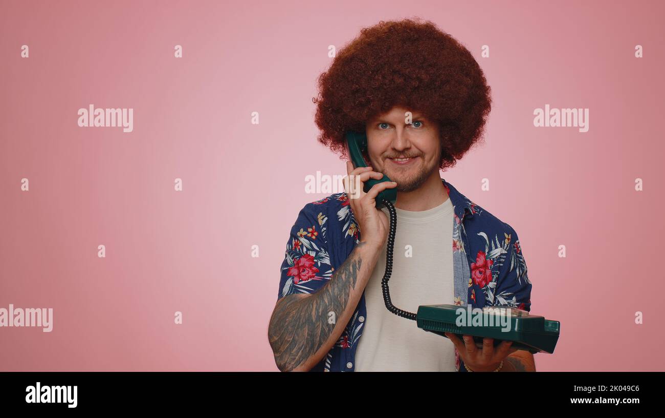 Hey you, call me back. Cheerful man secretary in blue shirt talking on ...