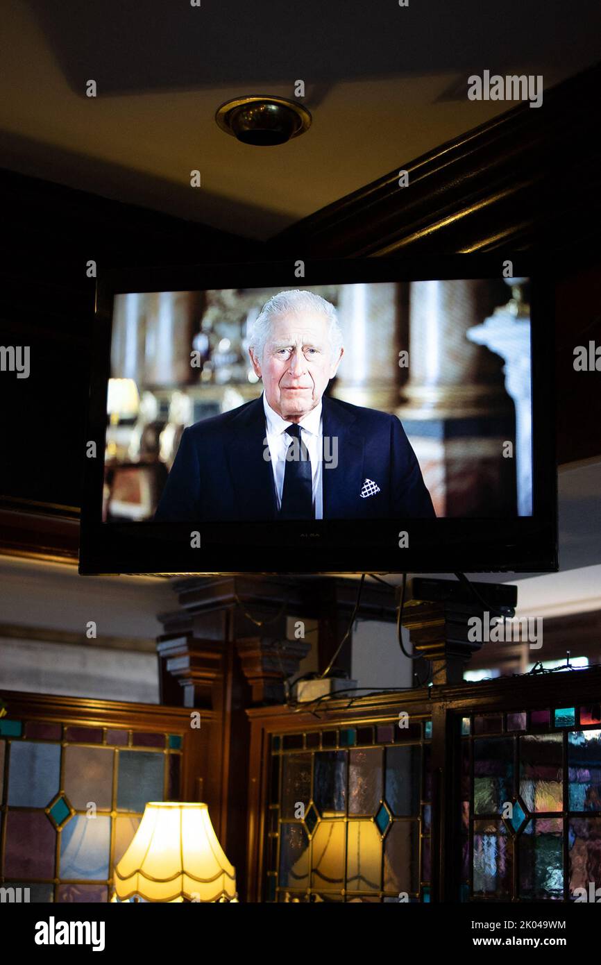 People watch King Charles III first television address as the King in a ...