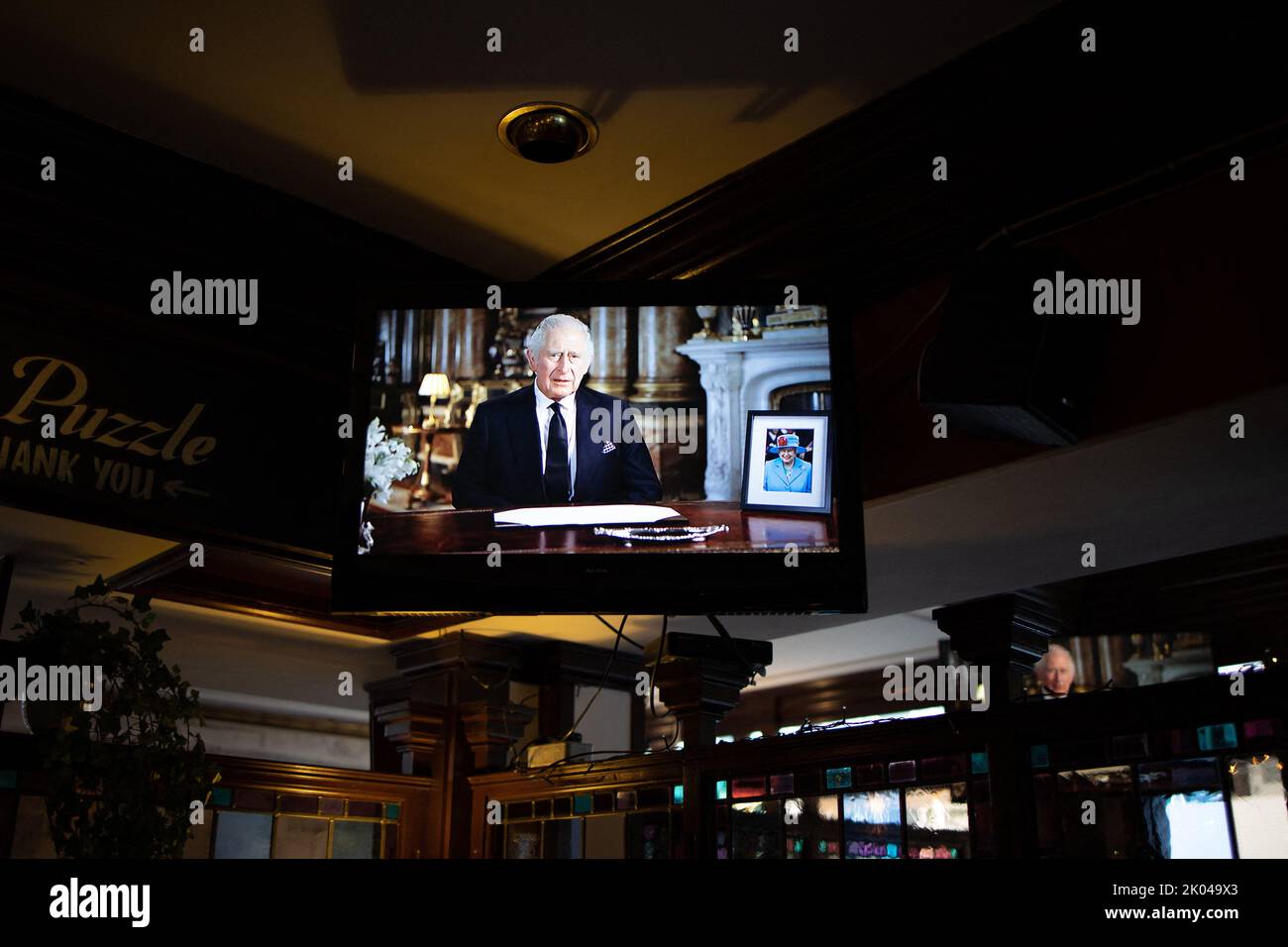 People watch King Charles III first television address as the King in a ...