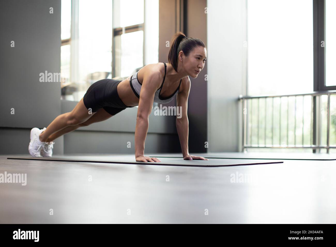 Young Chinese woman exercising at gym Stock Photo - Alamy