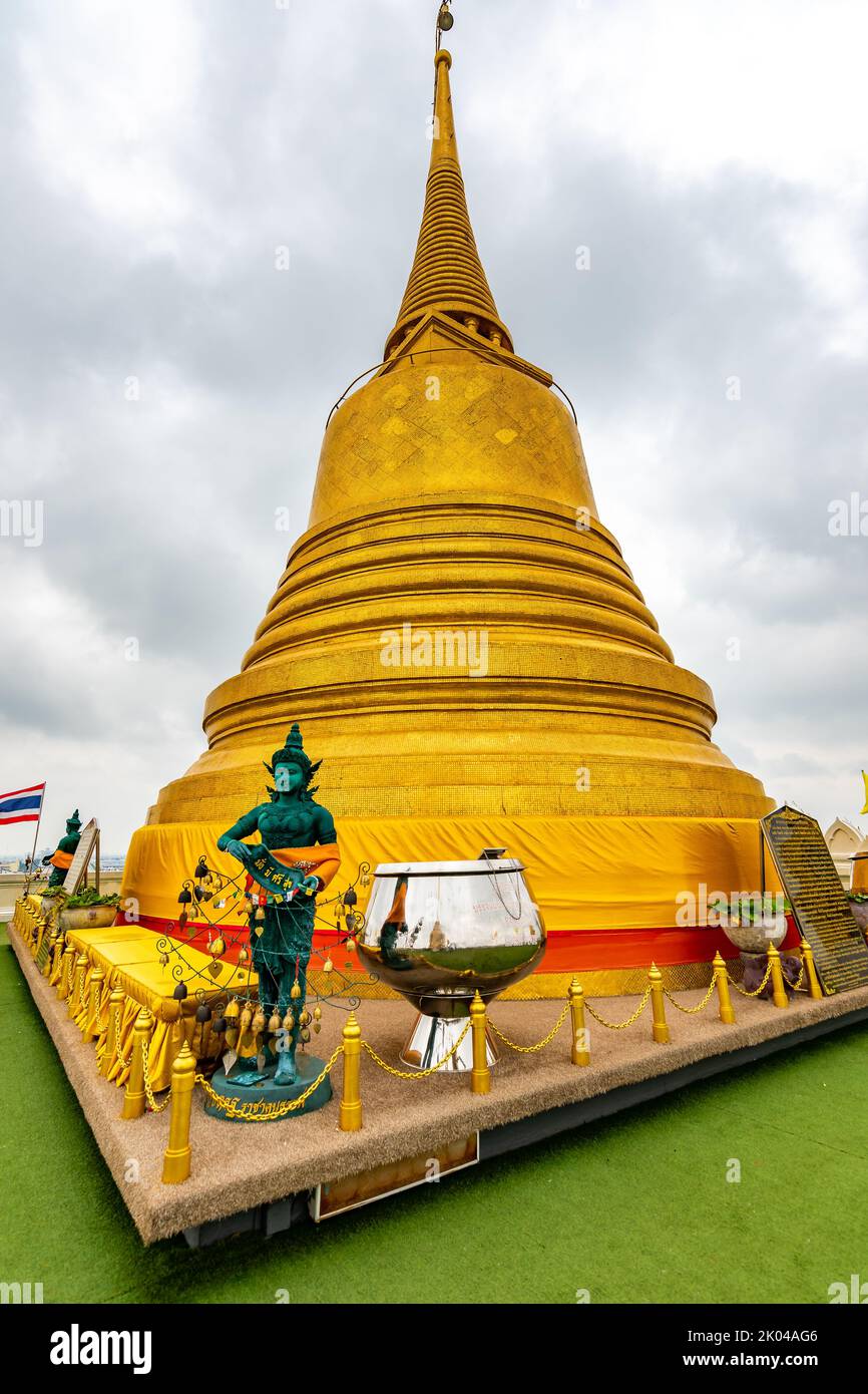 Wat Saket temple with golden stupa and angel statue. Symbol of buddhism ...