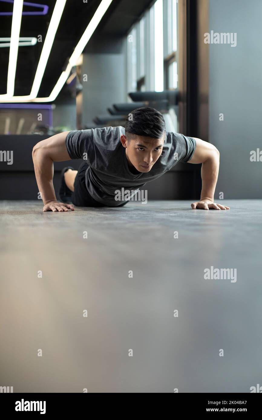 Young Chinese man exercising at gym Stock Photo - Alamy