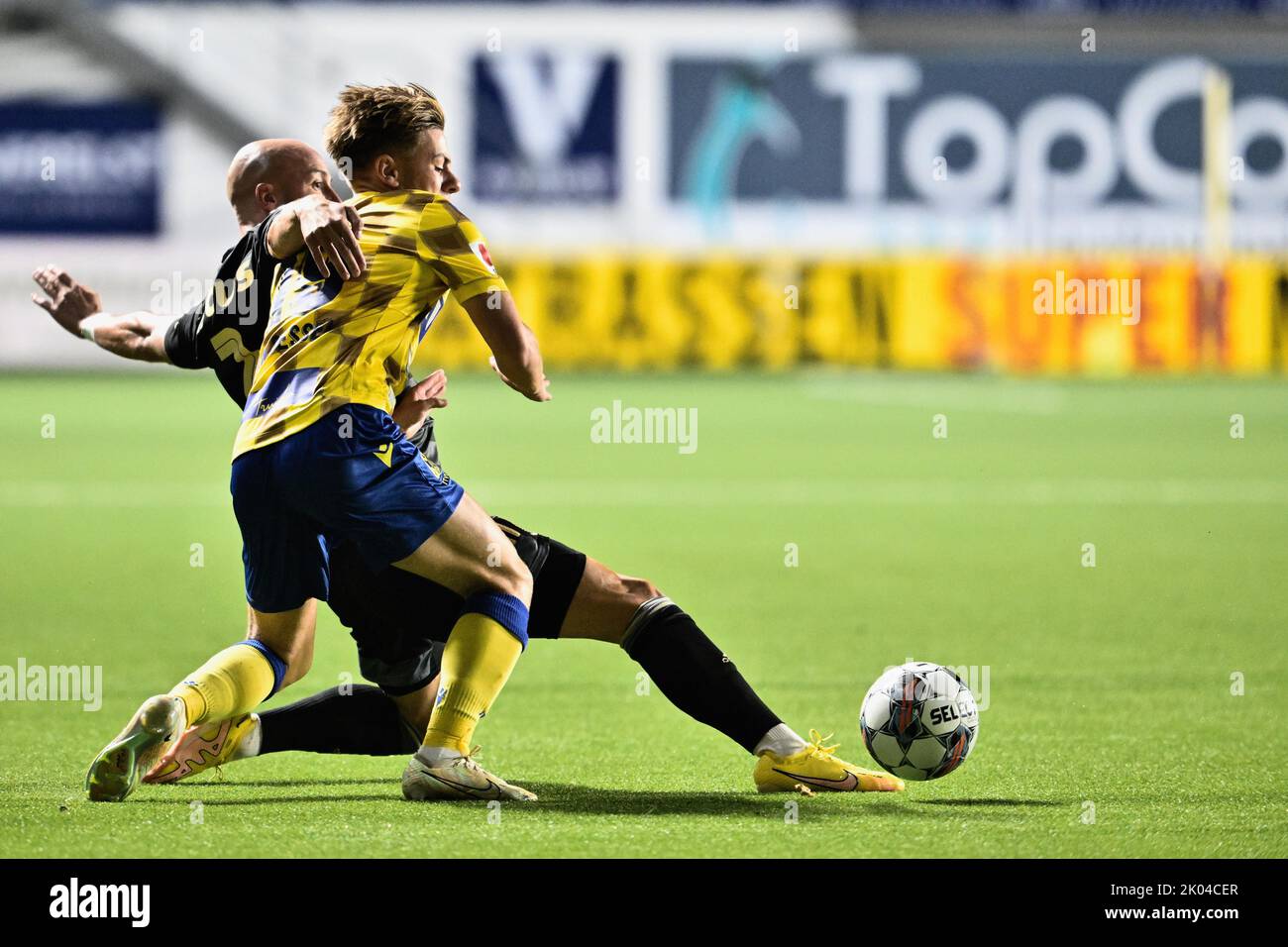Standard's Gilles Dewaele and STVV's Stan Van Dessel fight for the ball ...