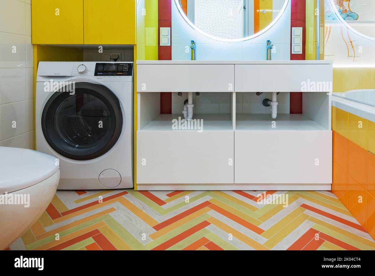 Washing machine and sink cupboard in the bathroom inside of the flat ...