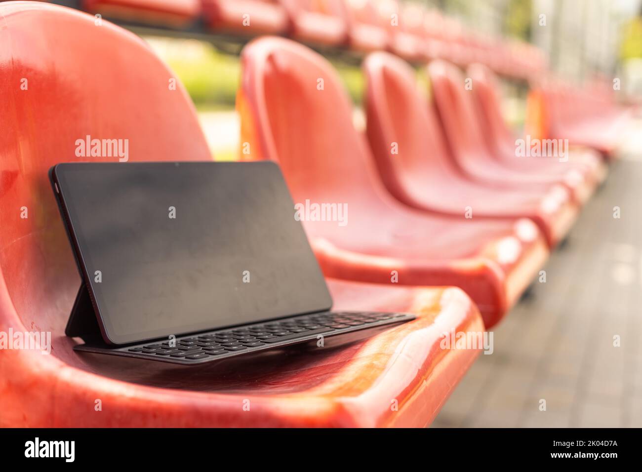 tablet on empty tribune of stadium on daytime Stock Photo - Alamy