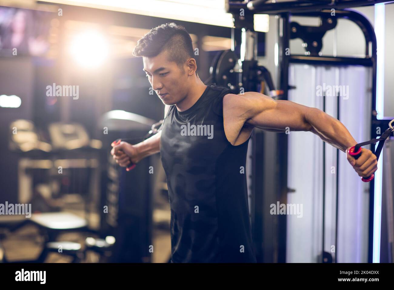 Young Chinese man exercising at gym Stock Photo - Alamy