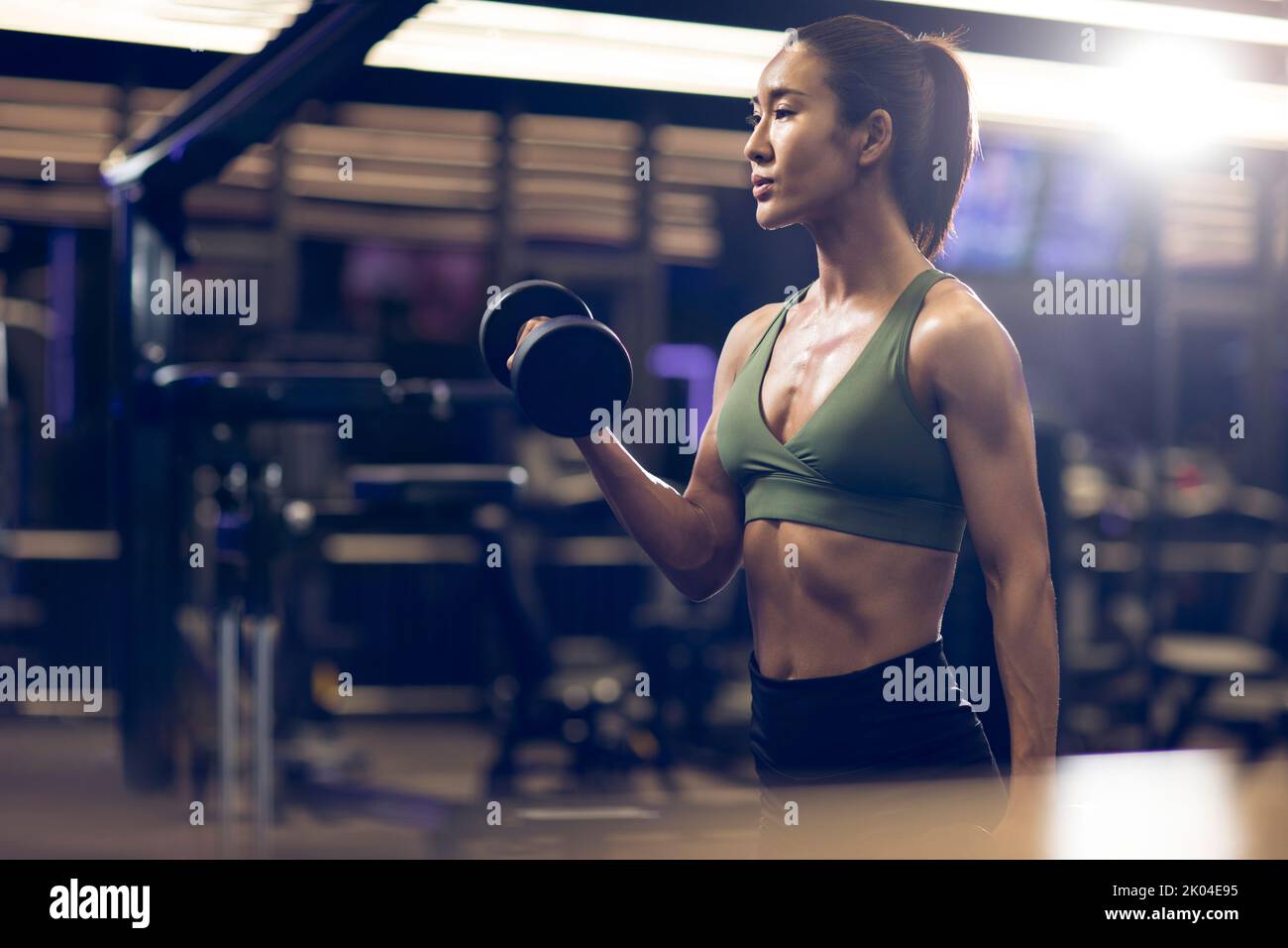 Young Chinese woman working out with dumbbell at gym Stock Photo - Alamy