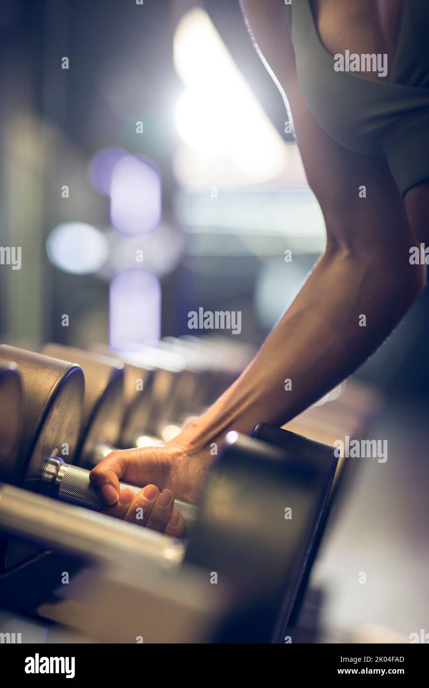 Young Chinese woman working out with dumbbell at gym Stock Photo - Alamy