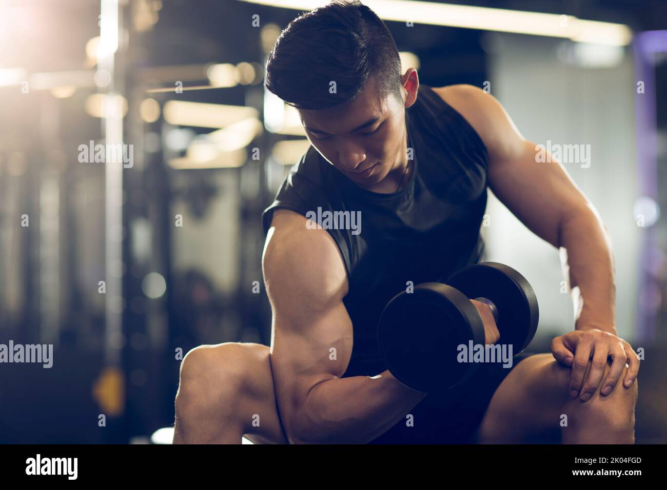 Young Chinese man working out with dumbbell at gym Stock Photo - Alamy