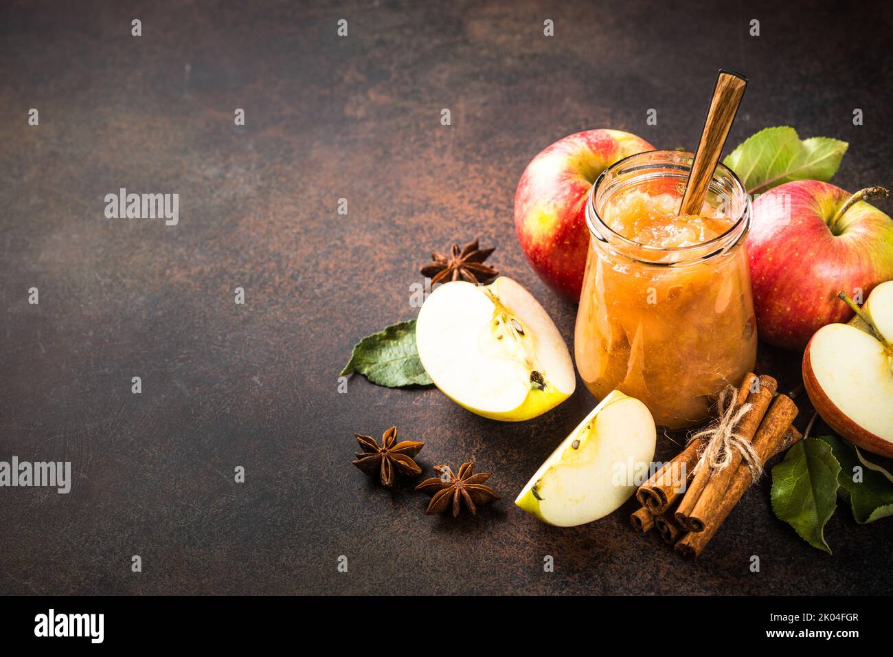 Apple jam with spices and fresh apples on dark background Stock Photo ...