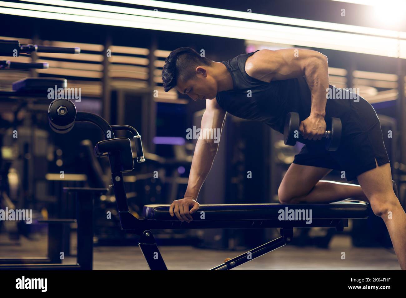 Young Chinese man working out with dumbbell at gym Stock Photo - Alamy