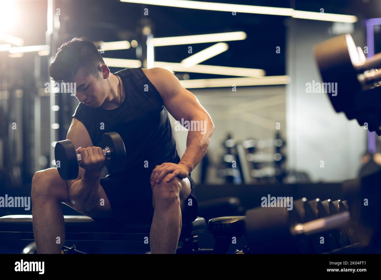 Young Chinese man working out with dumbbell at gym Stock Photo - Alamy