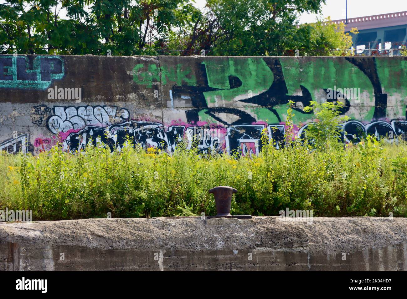 Graffiti on wall next to Cuyahoga river embankment in Cleveland Ohio ...