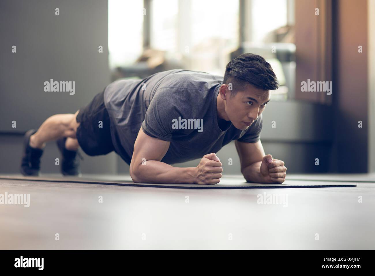 Young Chinese man exercising at gym Stock Photo - Alamy