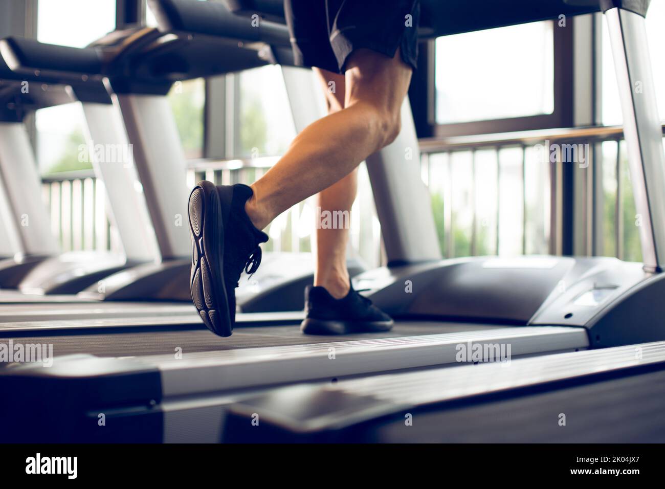Young Chinese man running on treadmill at gym Stock Photo - Alamy
